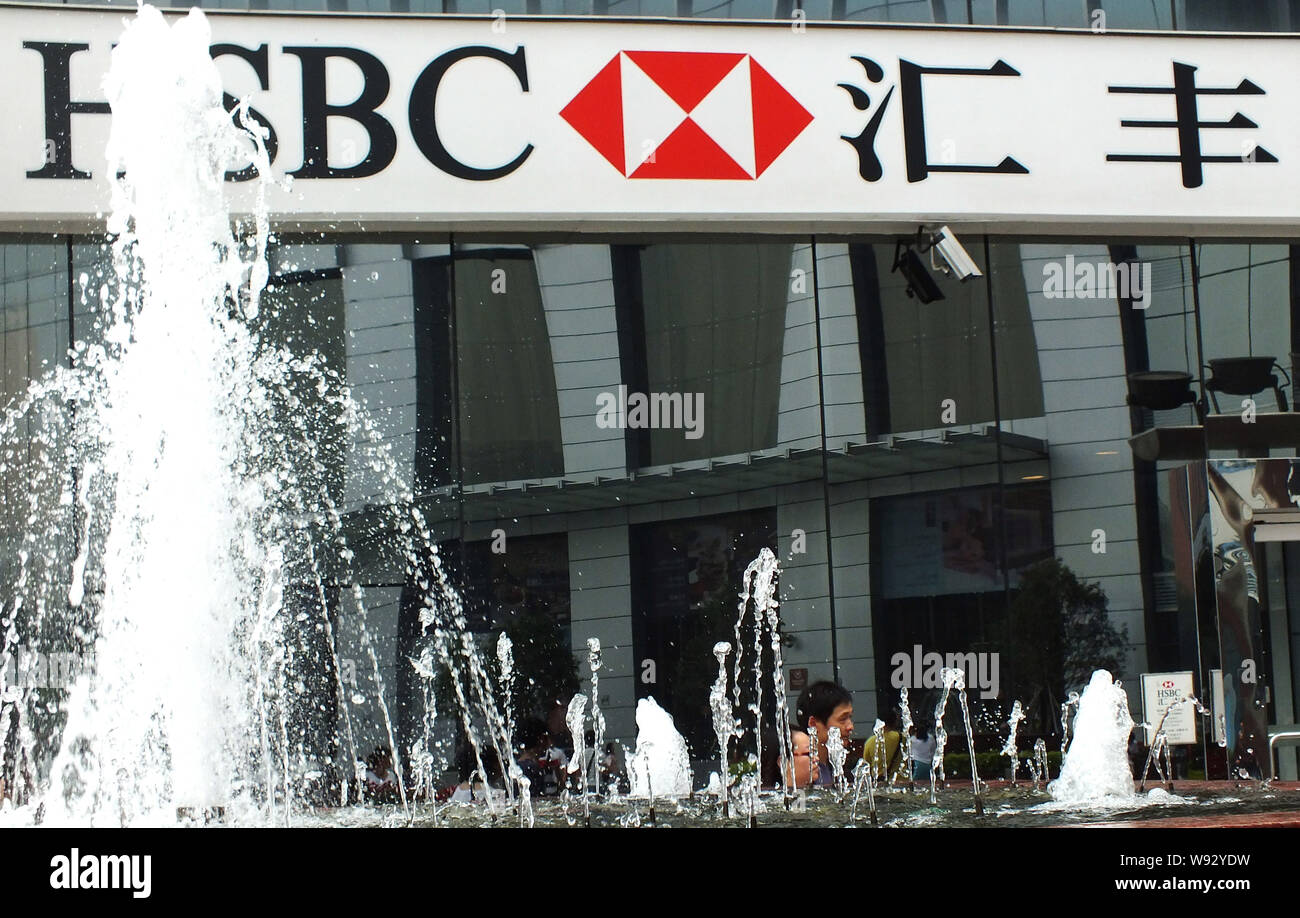 --FILE--Pedestrians walk past an advertisement for Hong Kong Shanghai Banking Corporation, known ...