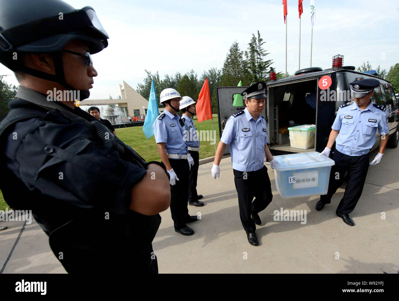 An armed Chinese special policeman stands guard as other police ...