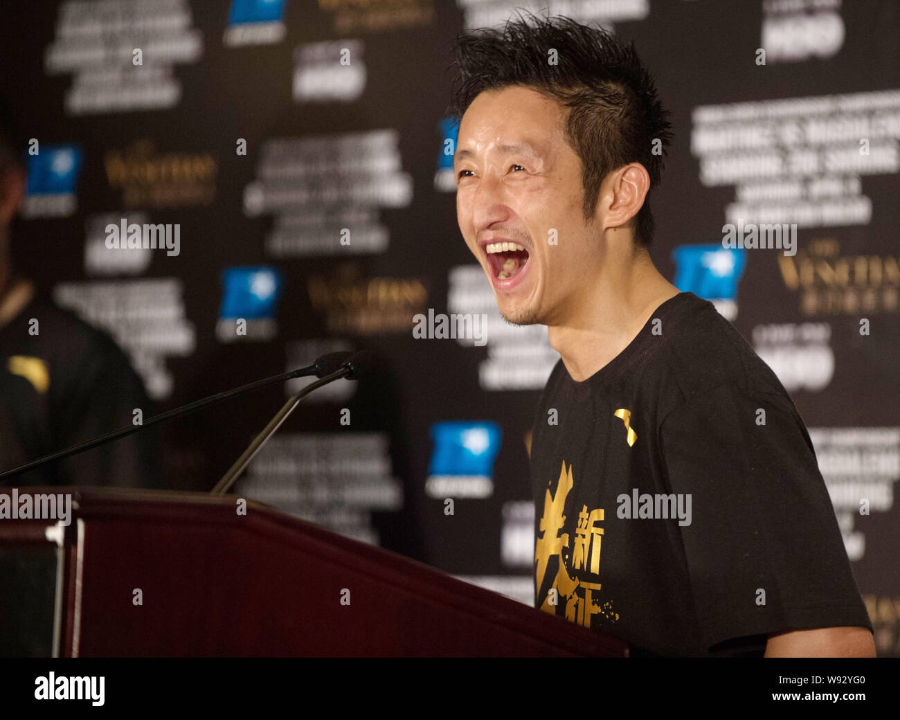 Chinese Olympic boxing champion Zou Shiming laughs during a press ...