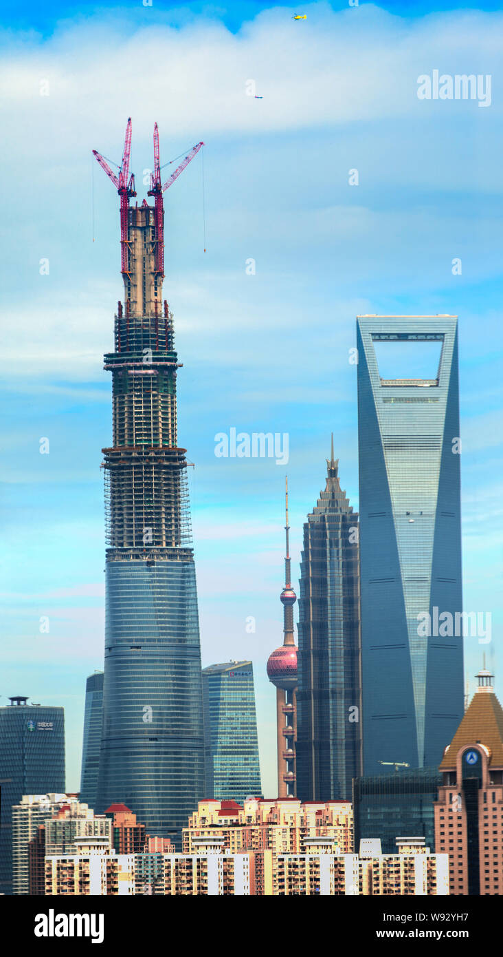 --FILE--The Shanghai Tower, tallest, is under construction next to ...