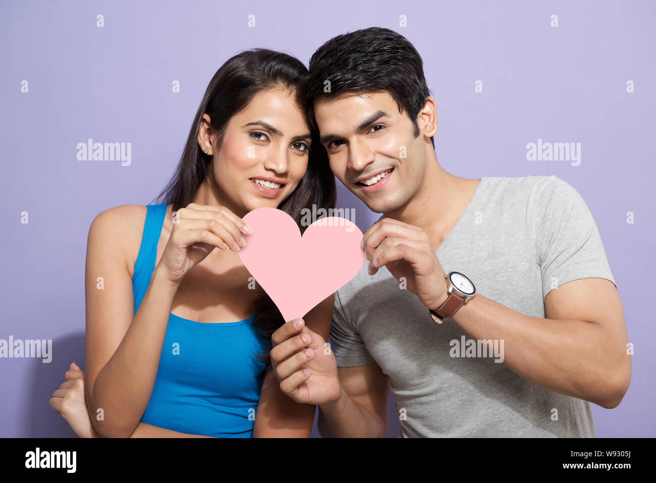 Young couple showing heart shape symbol Stock Photo - Alamy