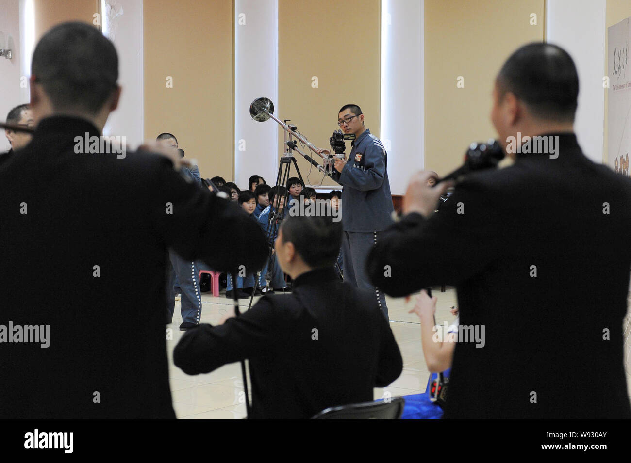 A Chinese inmate uses a camcorder to take videos of a performance to ...