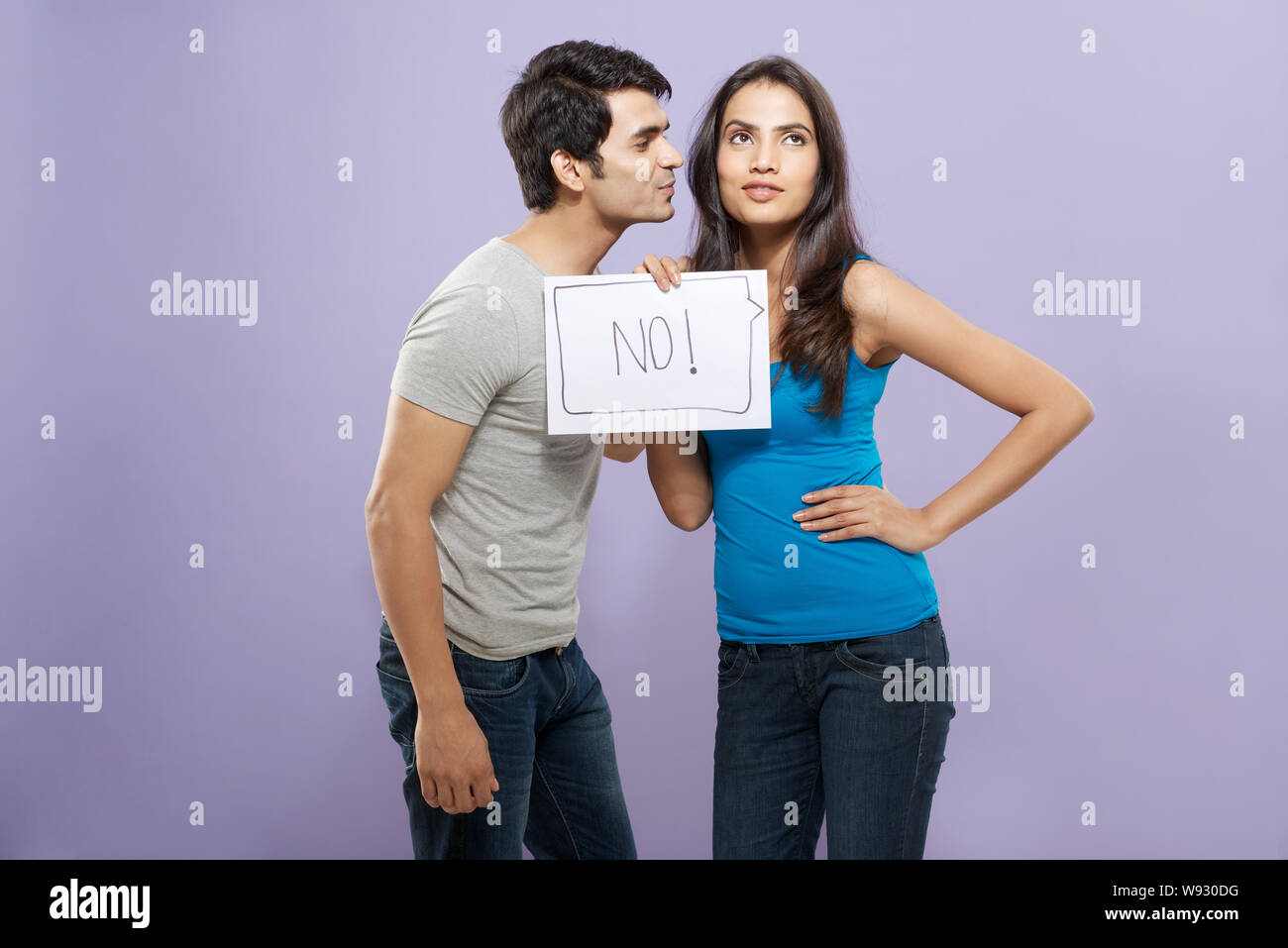 Young woman rejecting a young man trying to kiss her Stock Photo - Alamy