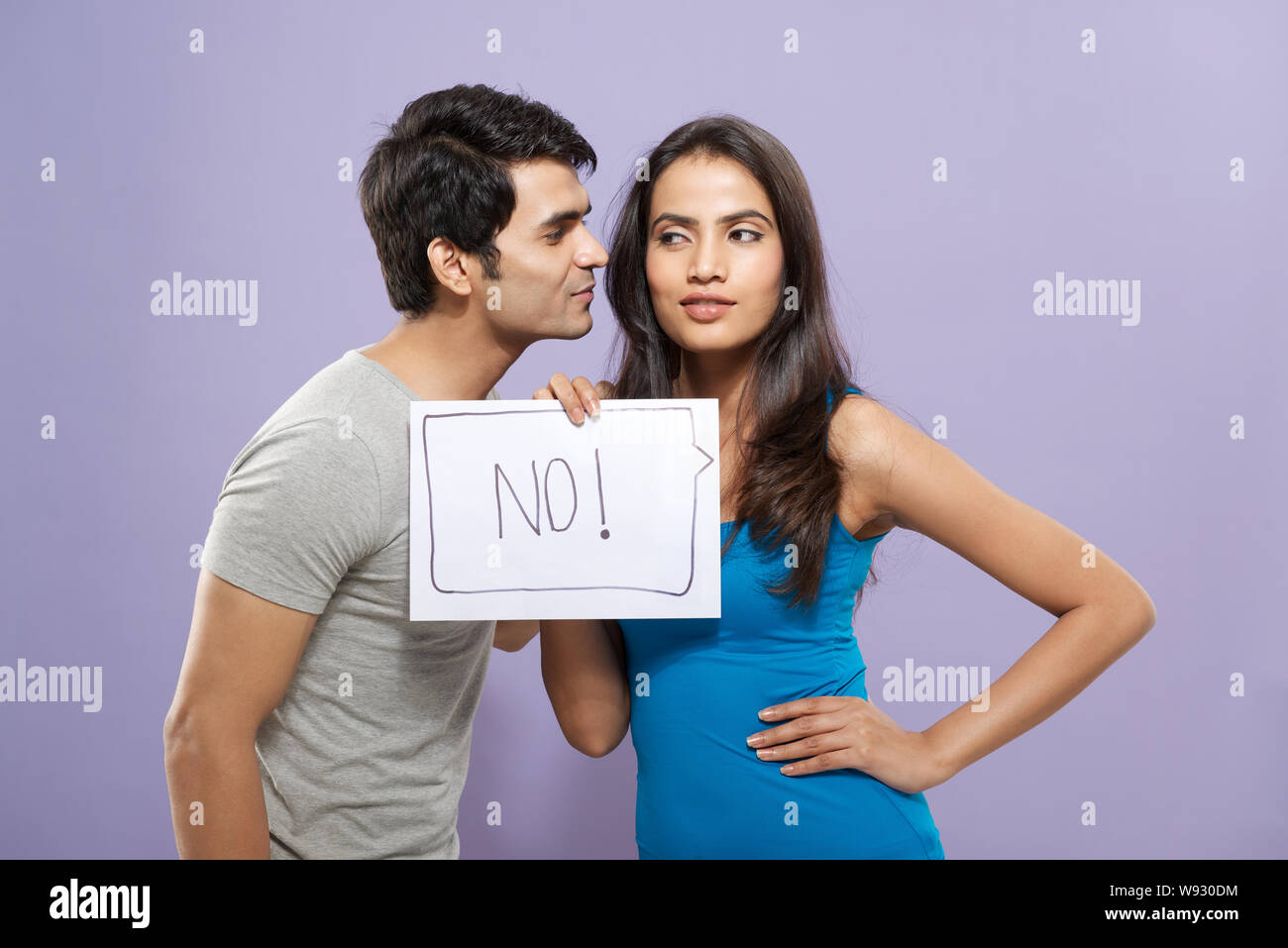 Young woman rejecting a young man trying to kiss her Stock Photo - Alamy