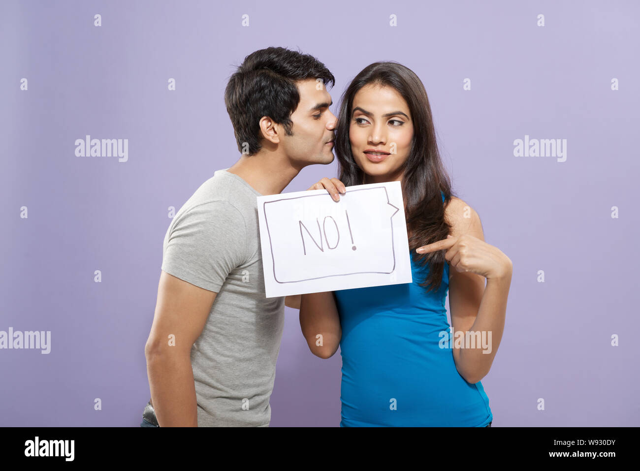 Young woman rejecting a young man trying to kiss her Stock Photo - Alamy