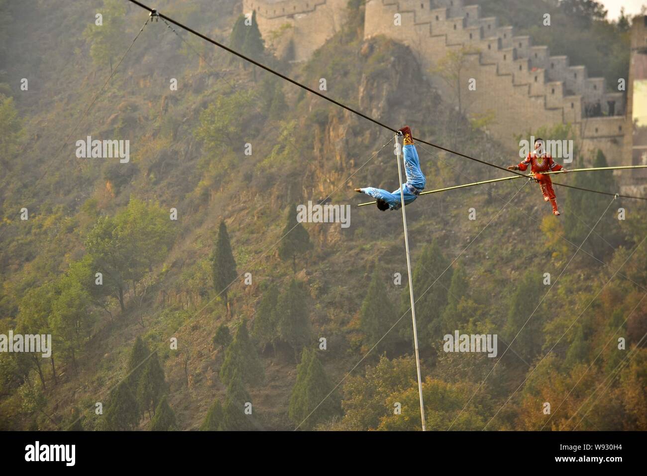 Chinas tightrope walking prince Adili Wuxor, back, and his student ...