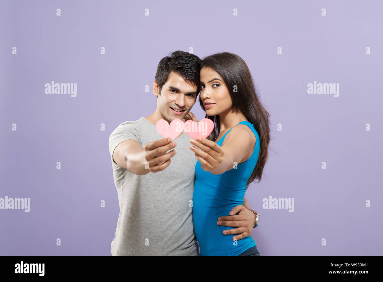 Young couple showing heart shape symbols Stock Photo - Alamy