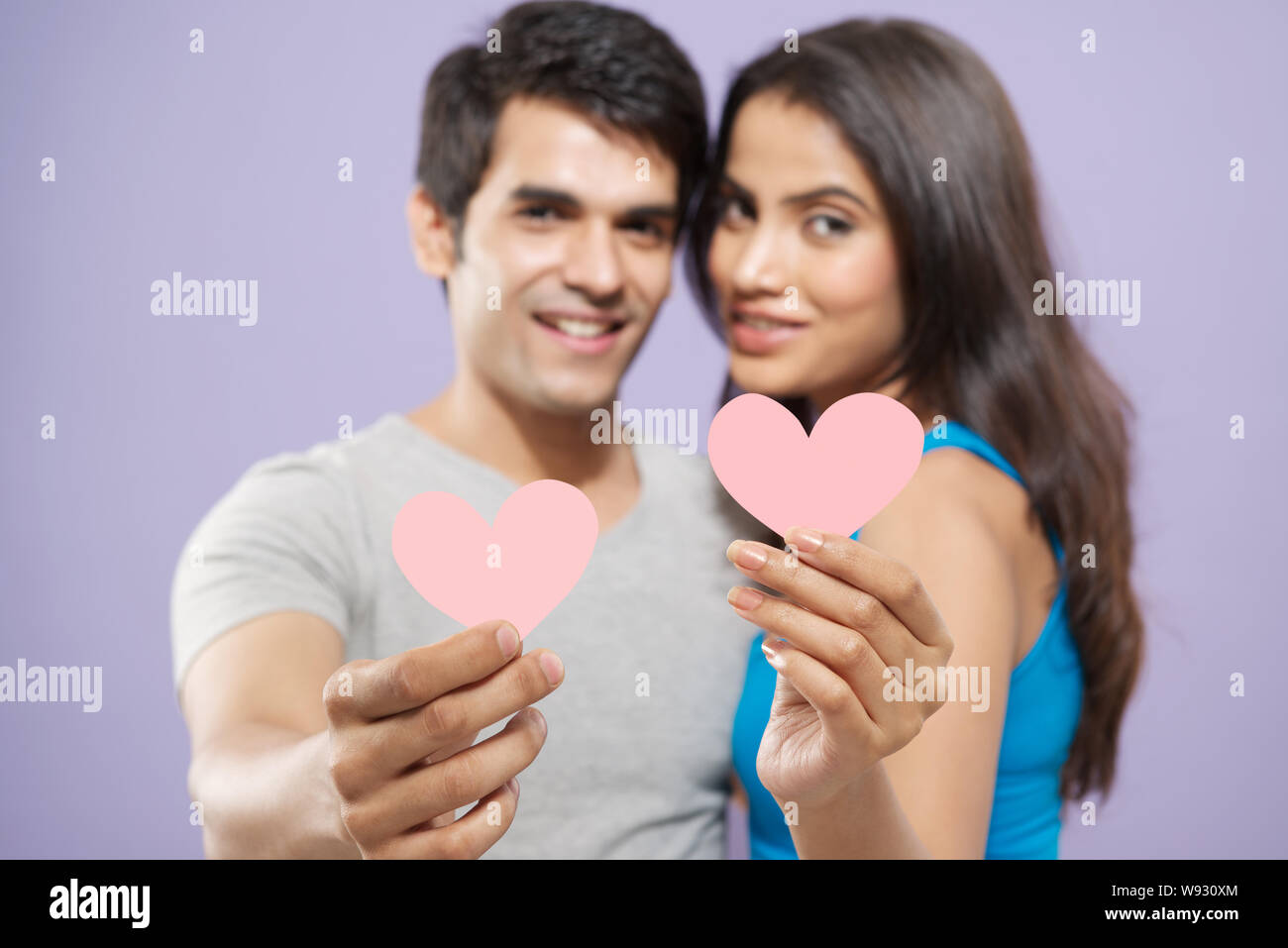 Young couple showing heart shape symbols Stock Photo - Alamy