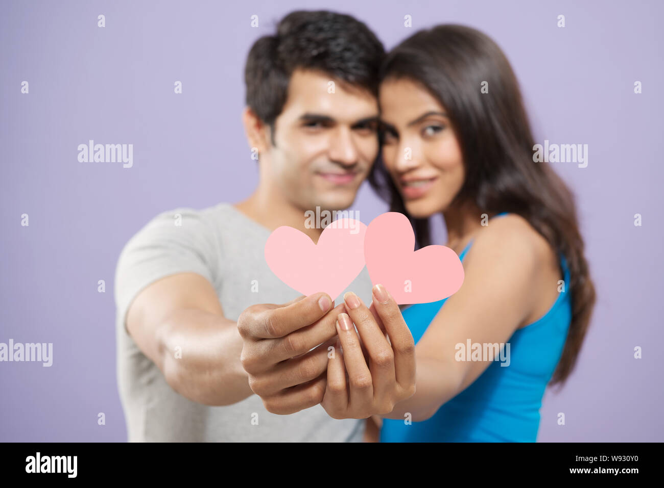 Young couple showing heart shape symbols Stock Photo - Alamy