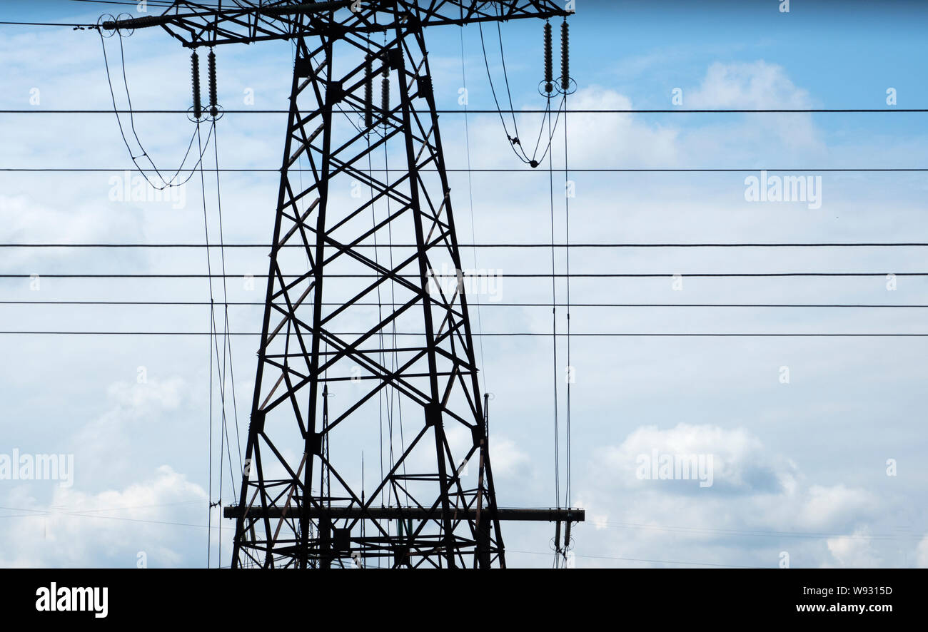 Power line against the blue sky with clouds Stock Photo - Alamy