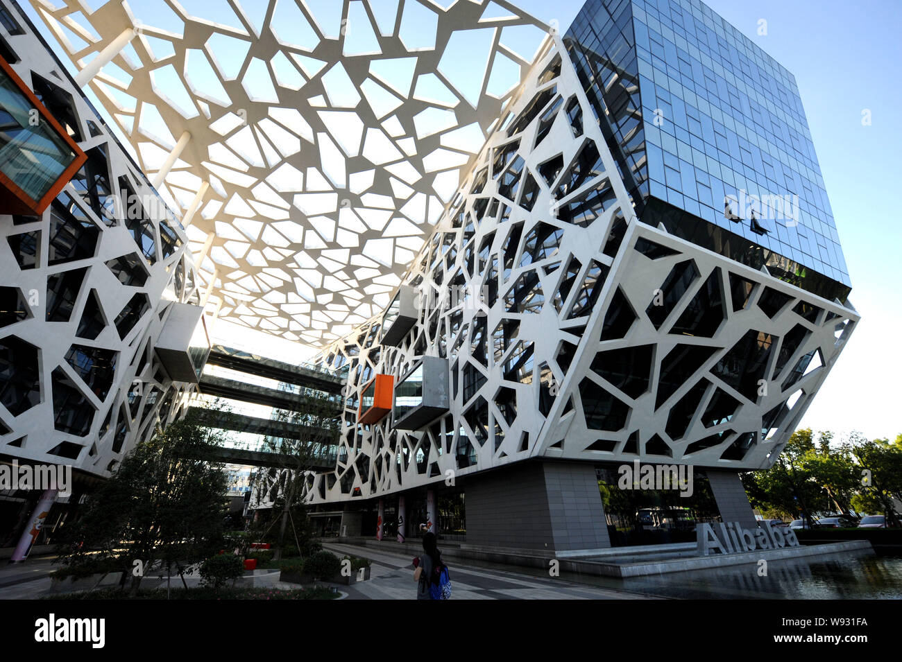 A pedestrian enters the headquarters and head office of Alibaba in ...