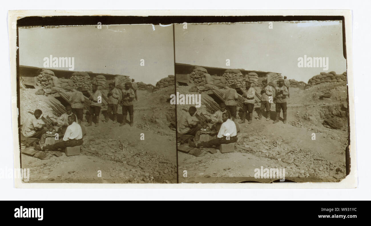 A soldier-cobbler mending boots in a Russian redoubt during a lull in ...