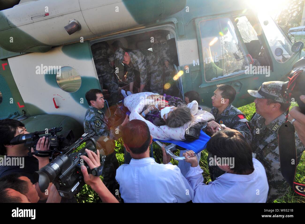 Chinese rescuers put a woman injured in the 6.6-magnitude earthquake ...