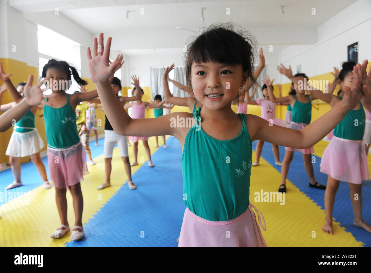 Young Chinese girls learn dancing at a dance school during their summer ...
