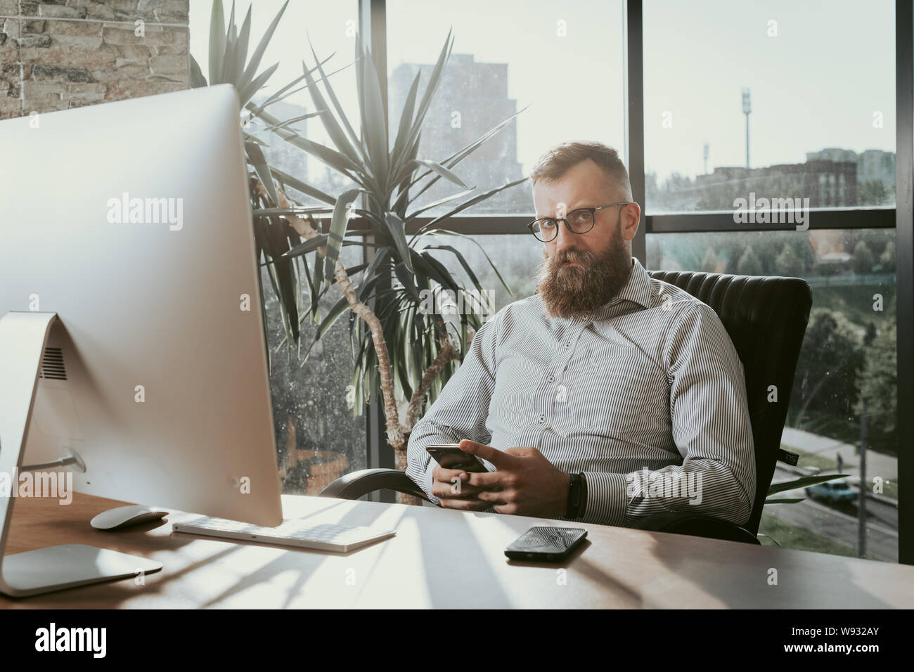 Boss sitting behind desk hi-res stock photography and images - Alamy