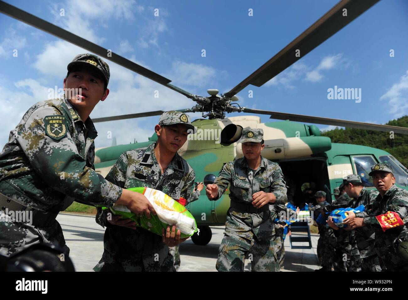 Chinese PLA (Peoples Liberation Army) soldiers unload relief goods from ...