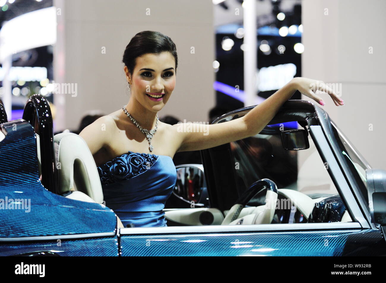 A model poses in a car during the 15th Shanghai International ...