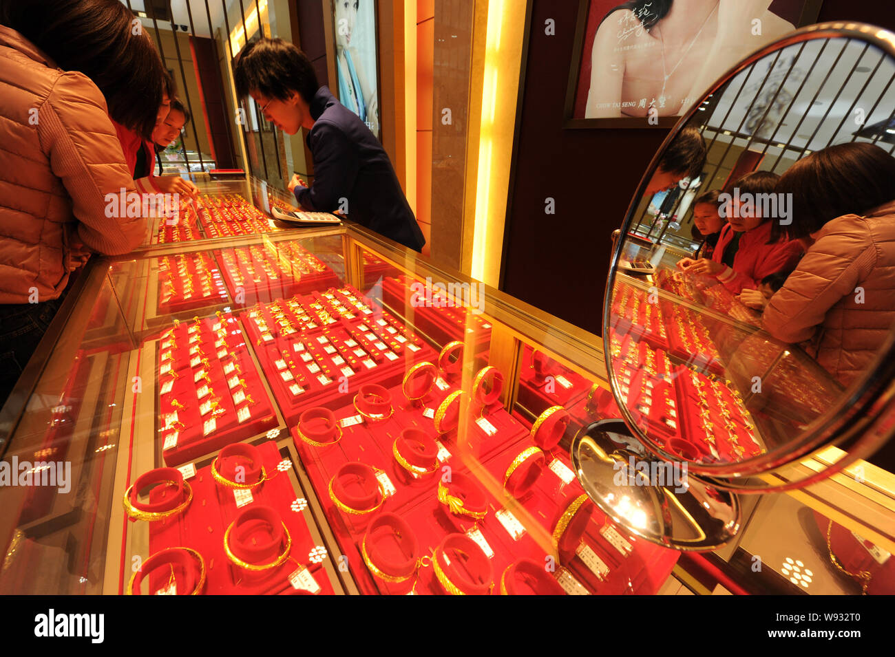 Chinese customers buy gold ornaments at a jewelry store in Taicang city ...