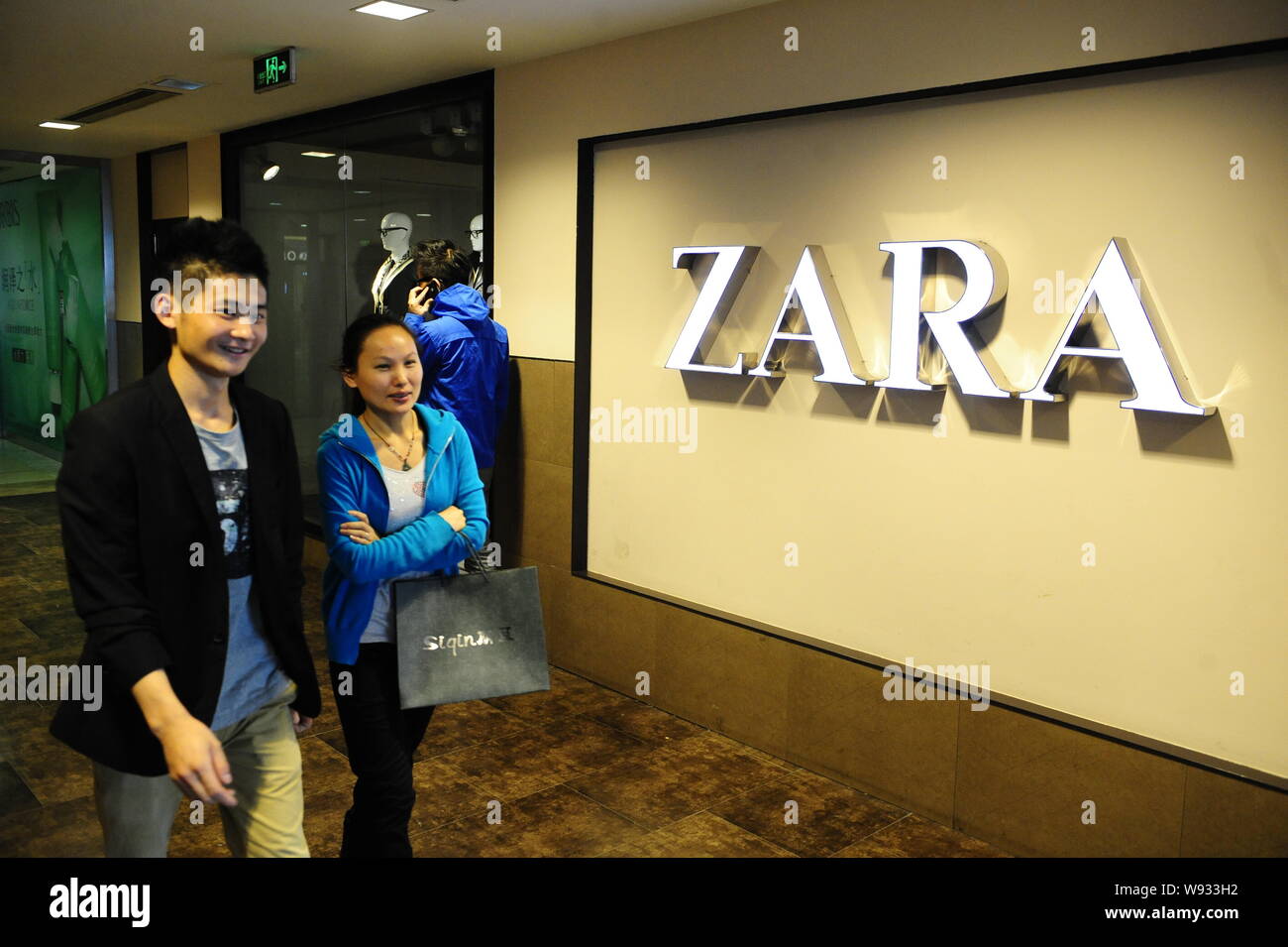 --FILE--Pedestrians walk past a store of Spanish fast fashion brand ...