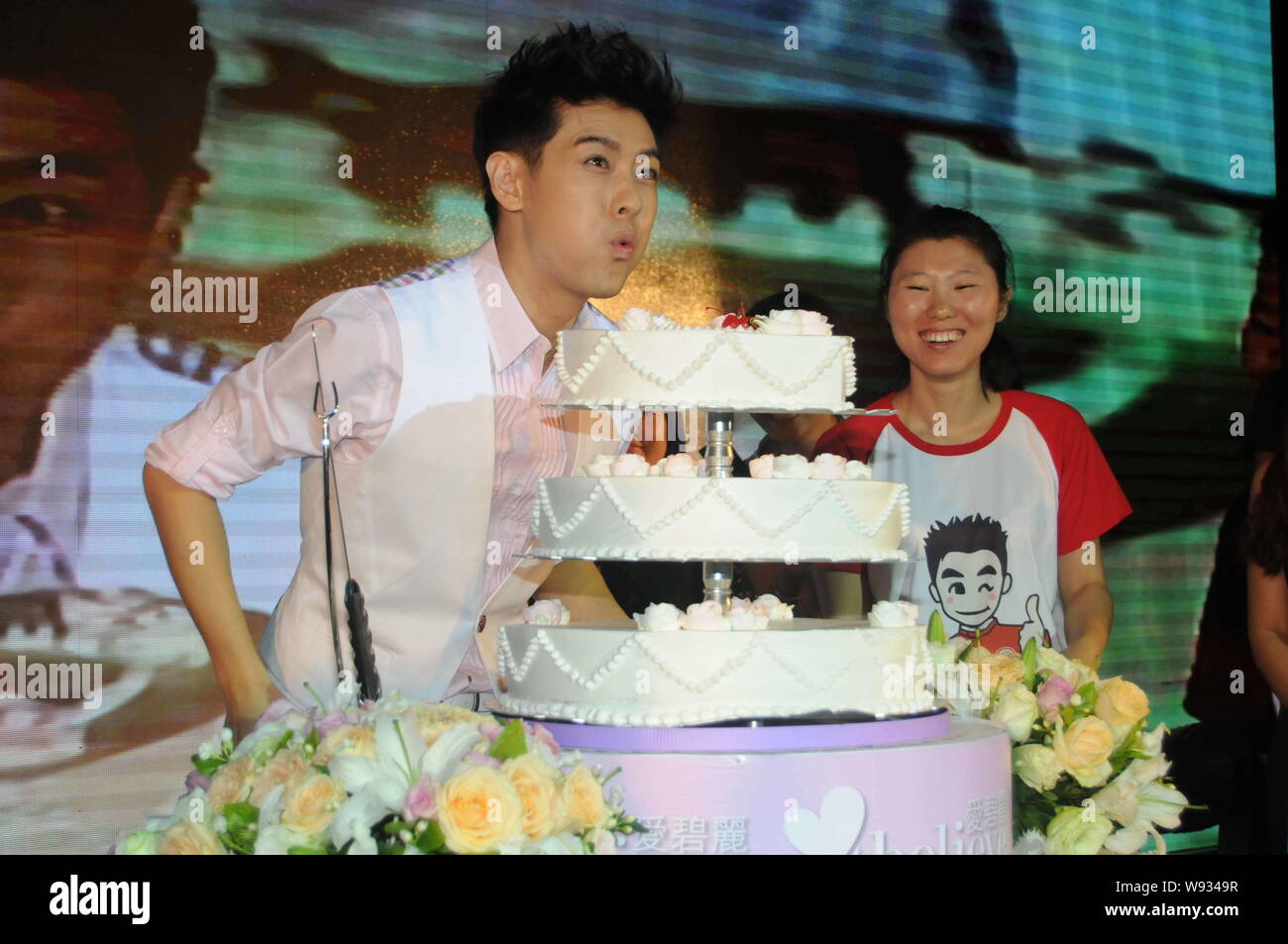 Taiwanese singer and actor Jimmy Lin blows during his 39th birthday ...