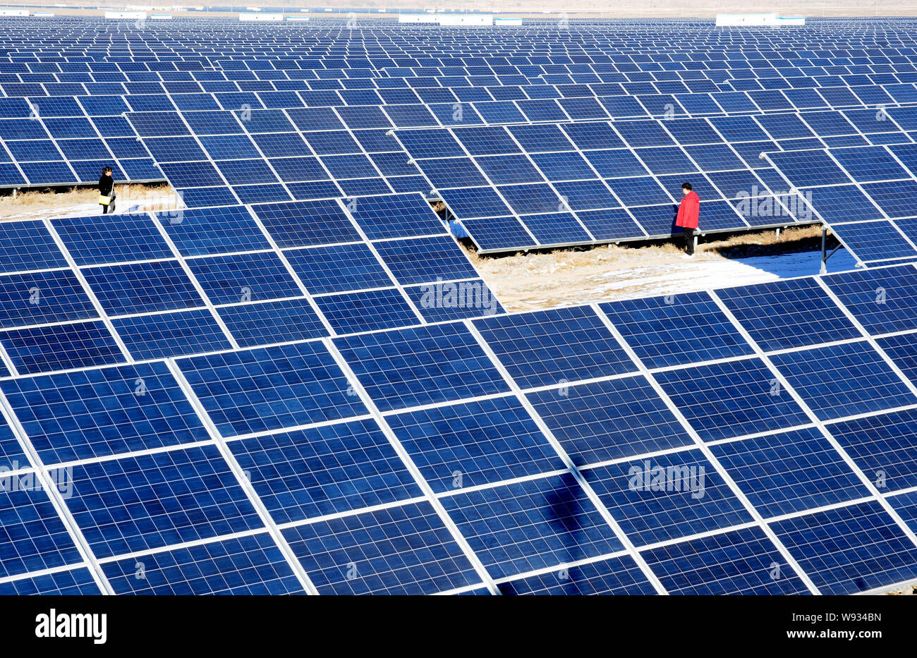 Chinese inspectors examine arrays of solar panels at a solar power ...