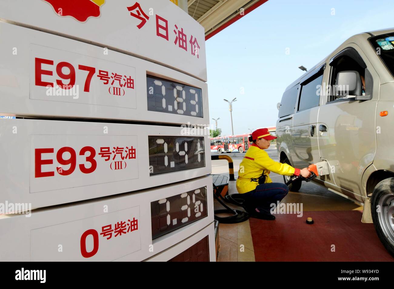A Chinese worker refuels a car at a gas station in Luoyang city ...