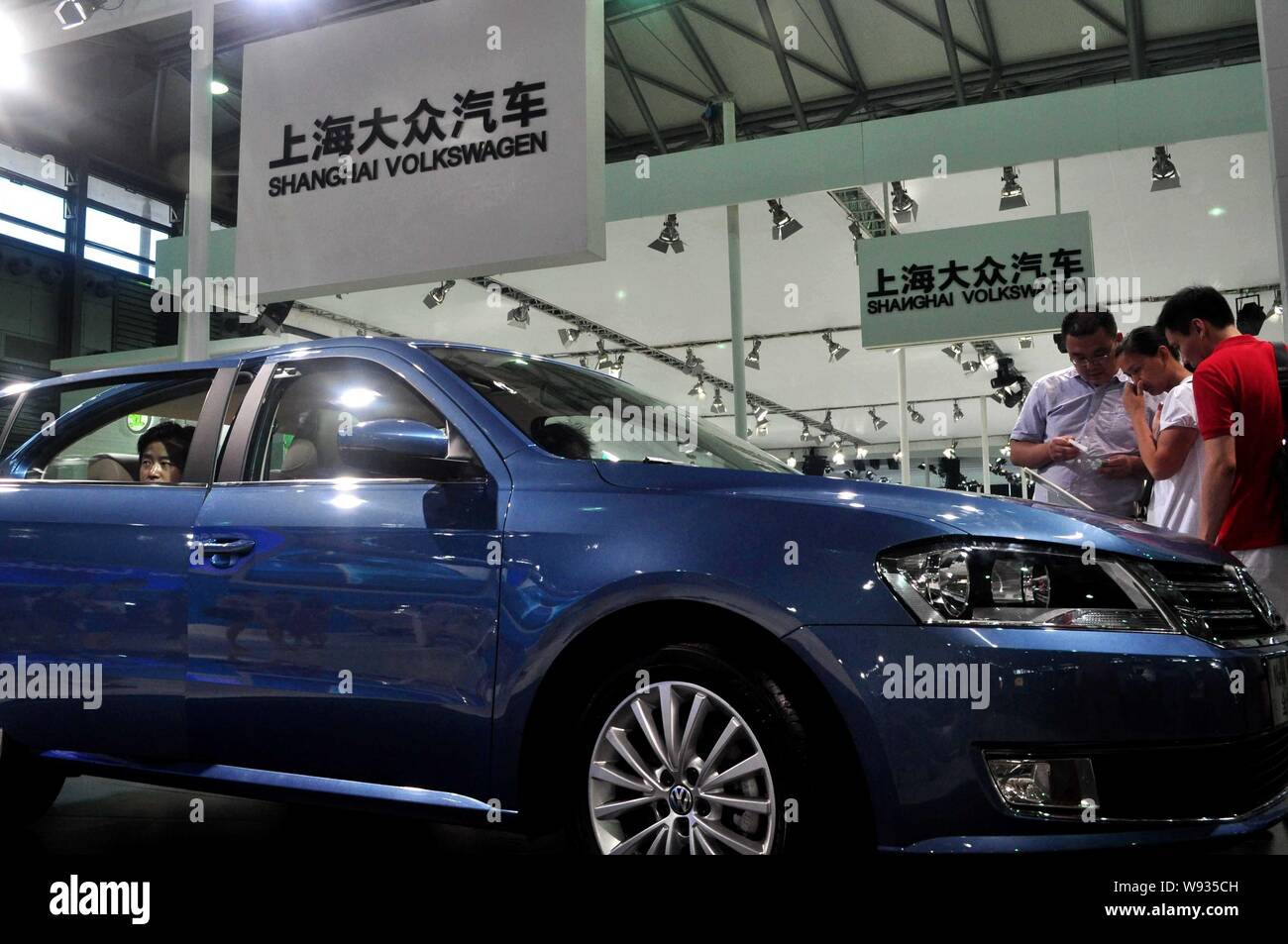 --FILE--Visitors look at a car of Shanghai Volkwagen during an ...
