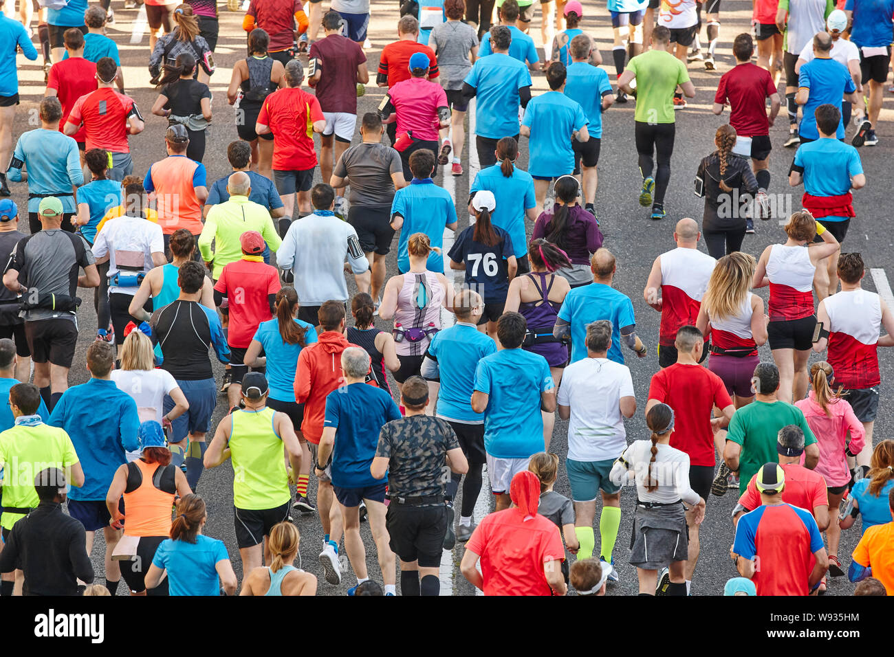 Runners on the street. Athletes in motion. Urban competition. Vertical ...