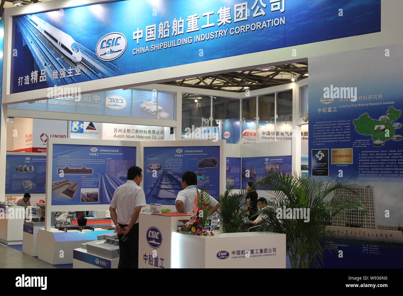 --FILE--Two employees are seen at the stand of China Shipbuilding ...