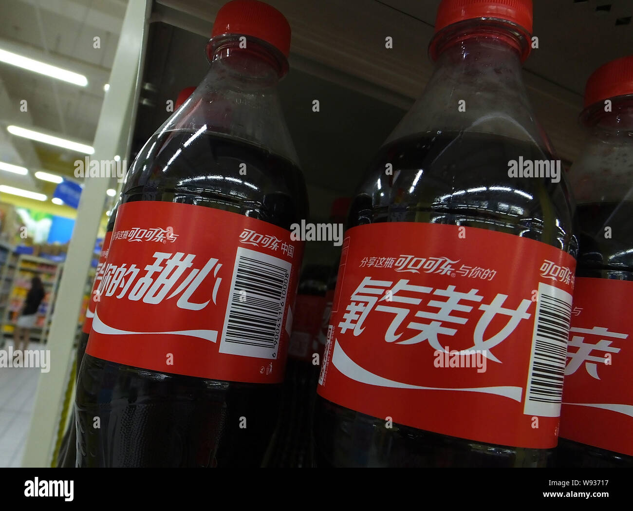 Bottles of Coca-Cola with new packaging are for sale on the shelf at a ...