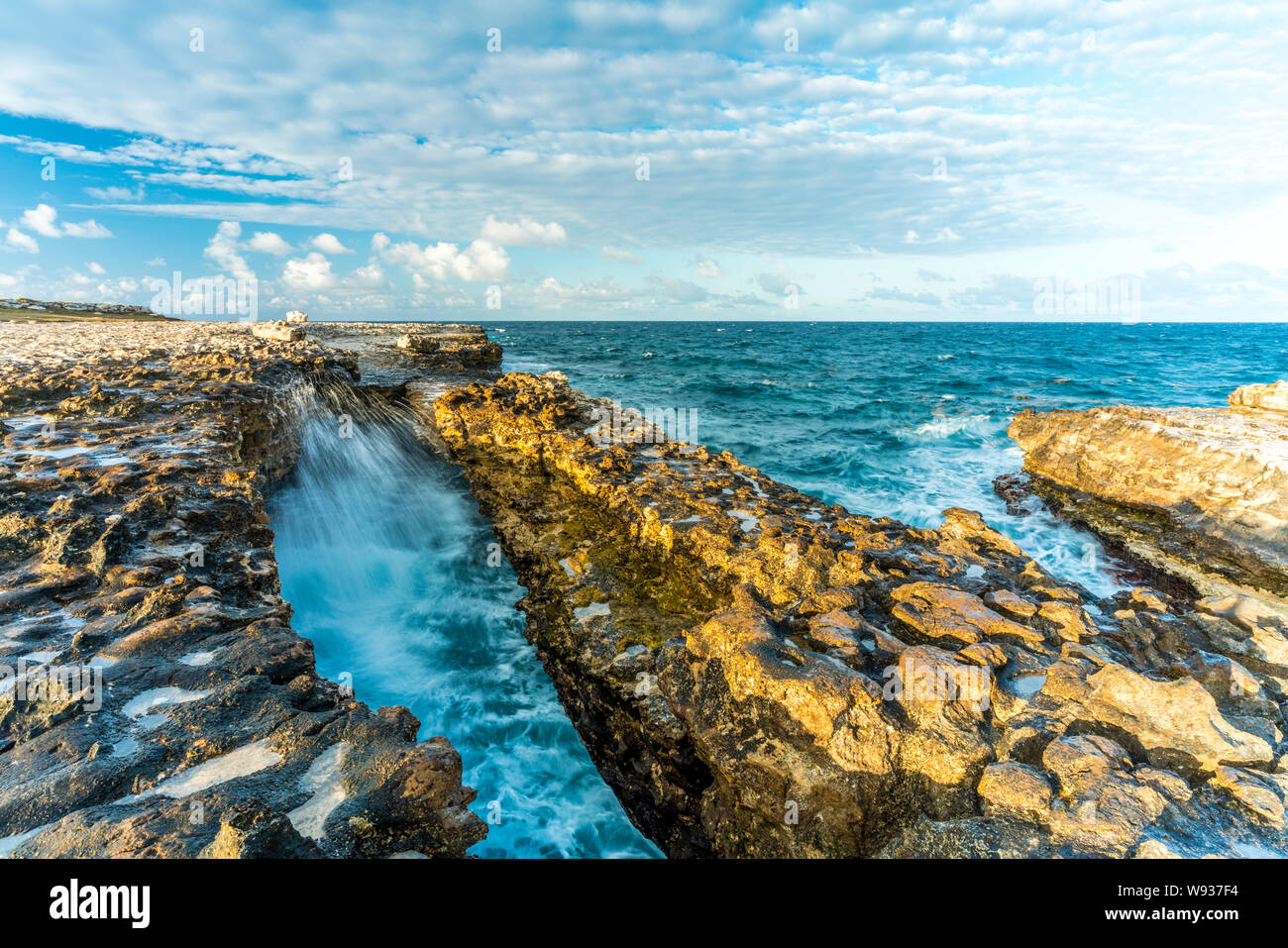 Waves in the natural arches of limestone carved by sea, Devil's Bridge ...