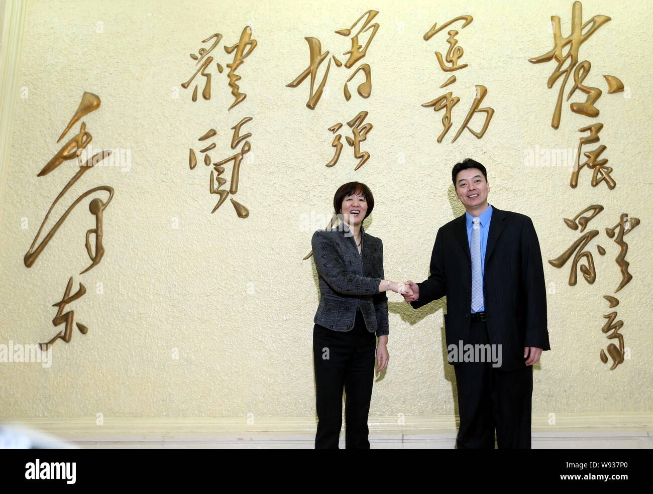 Lang Ping (left), also known as Jenny Lang, shakes hands with Xie ...