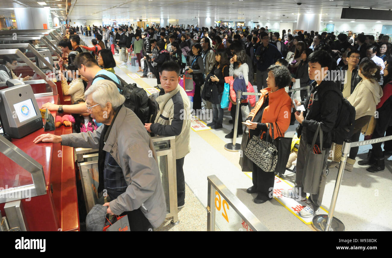 --FILE--Passengers from mainland China queue up to check in at the ...