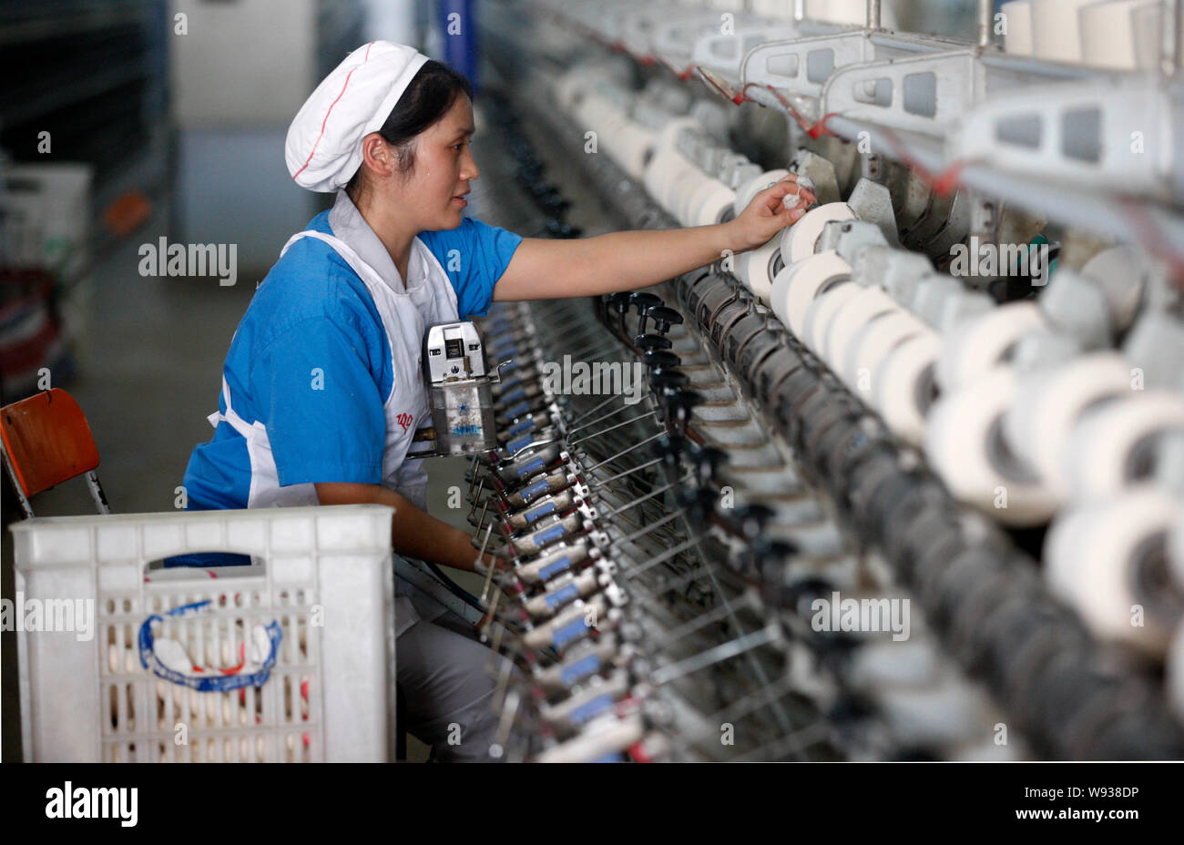 --FILE--A female Chinese worker handles production of yarn to be exported to South Korea at a ...