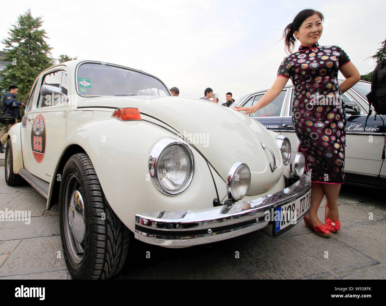 A visitor poses with a classic VW Beetle during the Classic Cars ...