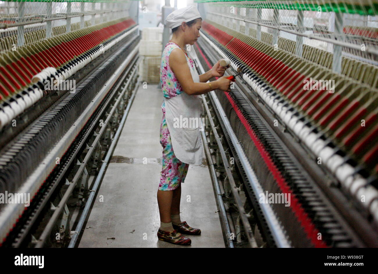 --FILE--A female Chinese worker handles production of yarn to be exported to South Korea at a ...