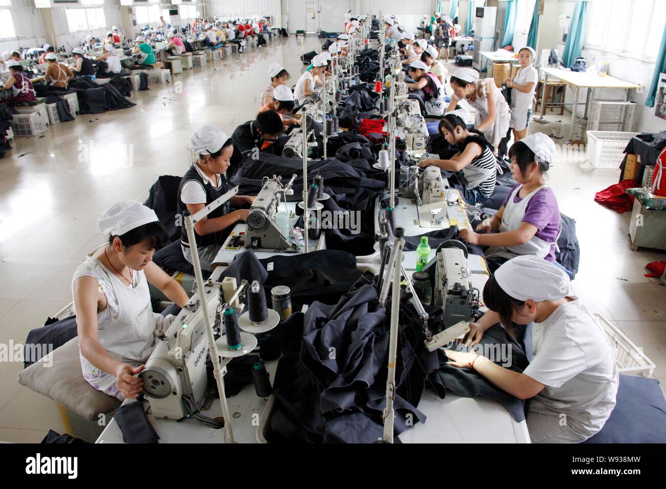 --FILE--Female Chinese workers sew clothes to be exported to Europe at a factory in Huaibei ...