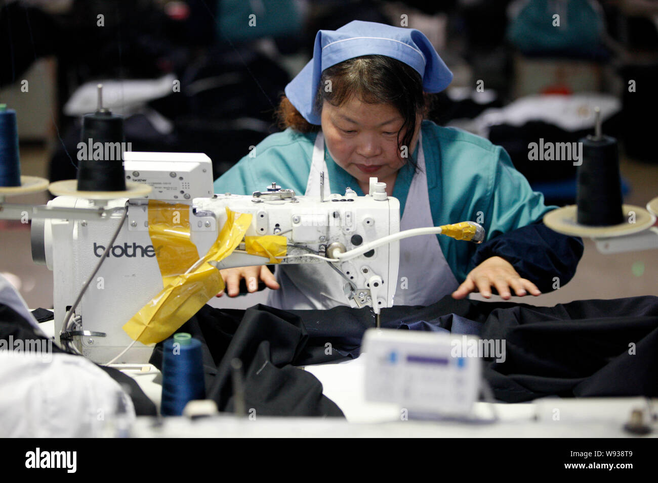 A female Chinese worker sews clothes to be exported to Europe at a garment factory in Huaibei ...