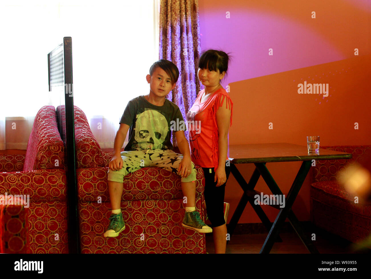 Dwarf waiter Wang Junfeng, left, poses with his waitress girlfriend at the Happy Island fairy ...