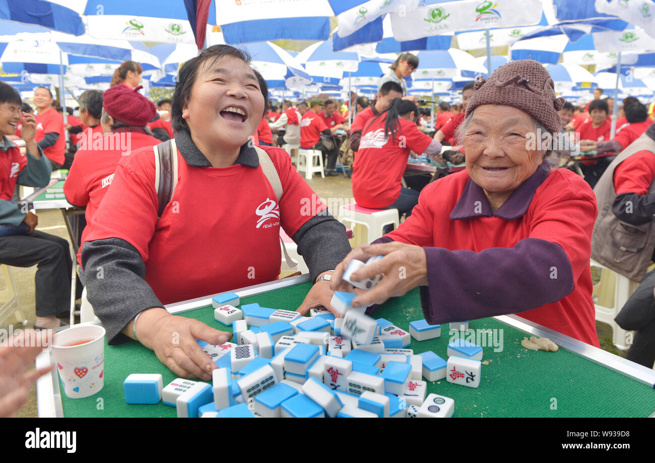 Local Chinese residents play mahjong at an event to break a Guinness ...