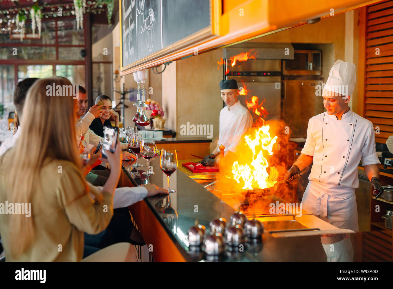 The chef prepares food in front of the visitors in the restaurant Stock ...