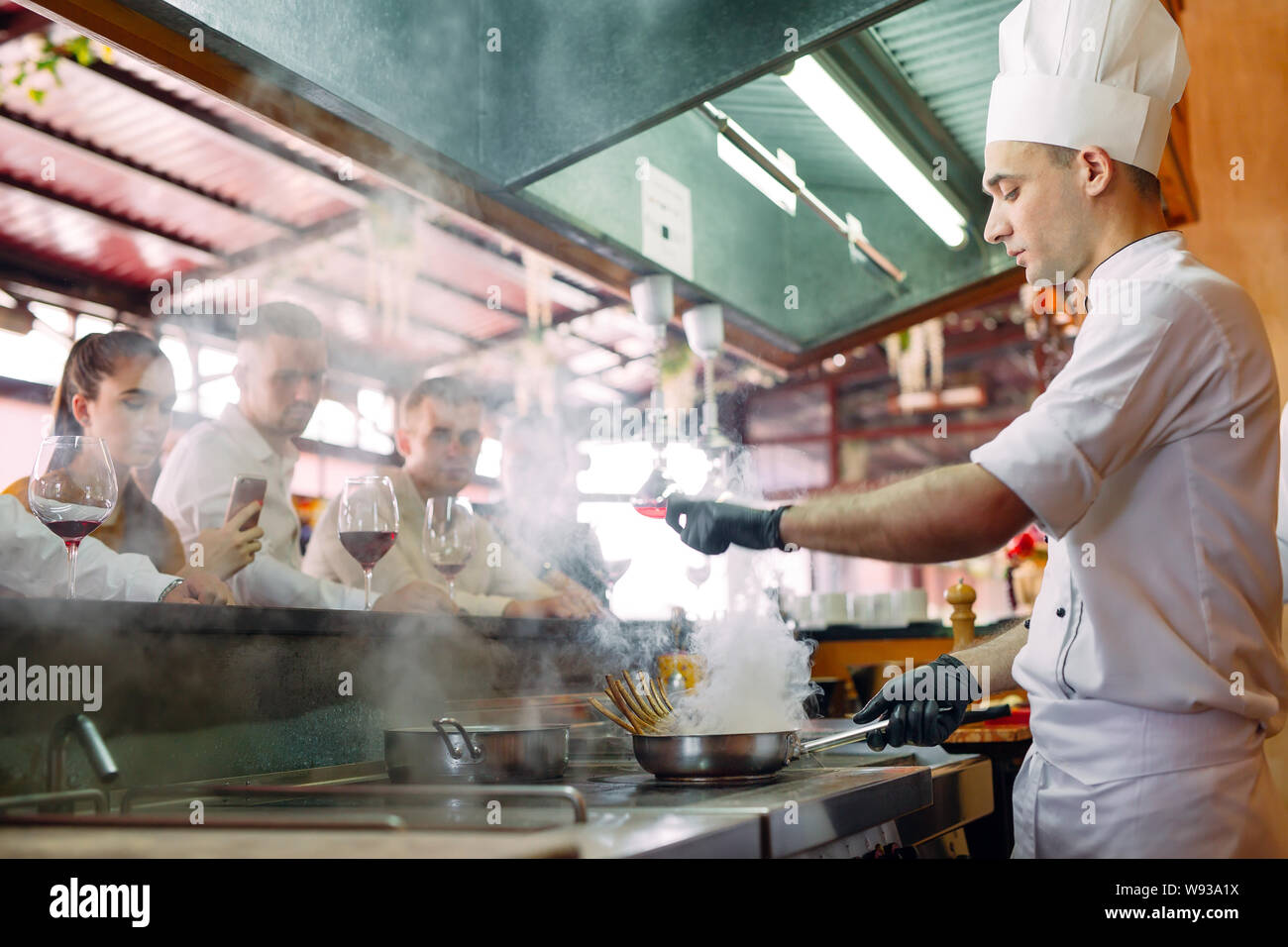 The chef prepares food in front of the visitors in the restaurant Stock ...
