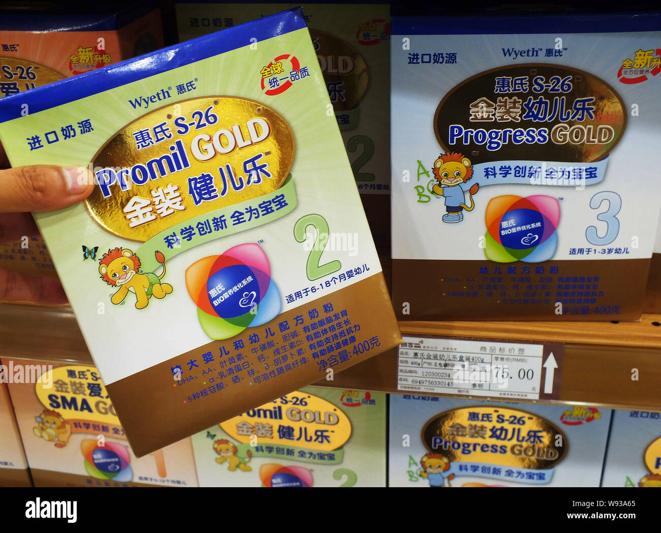 A customer buys Wyeth baby formula at a supermarket in Yichang city ...