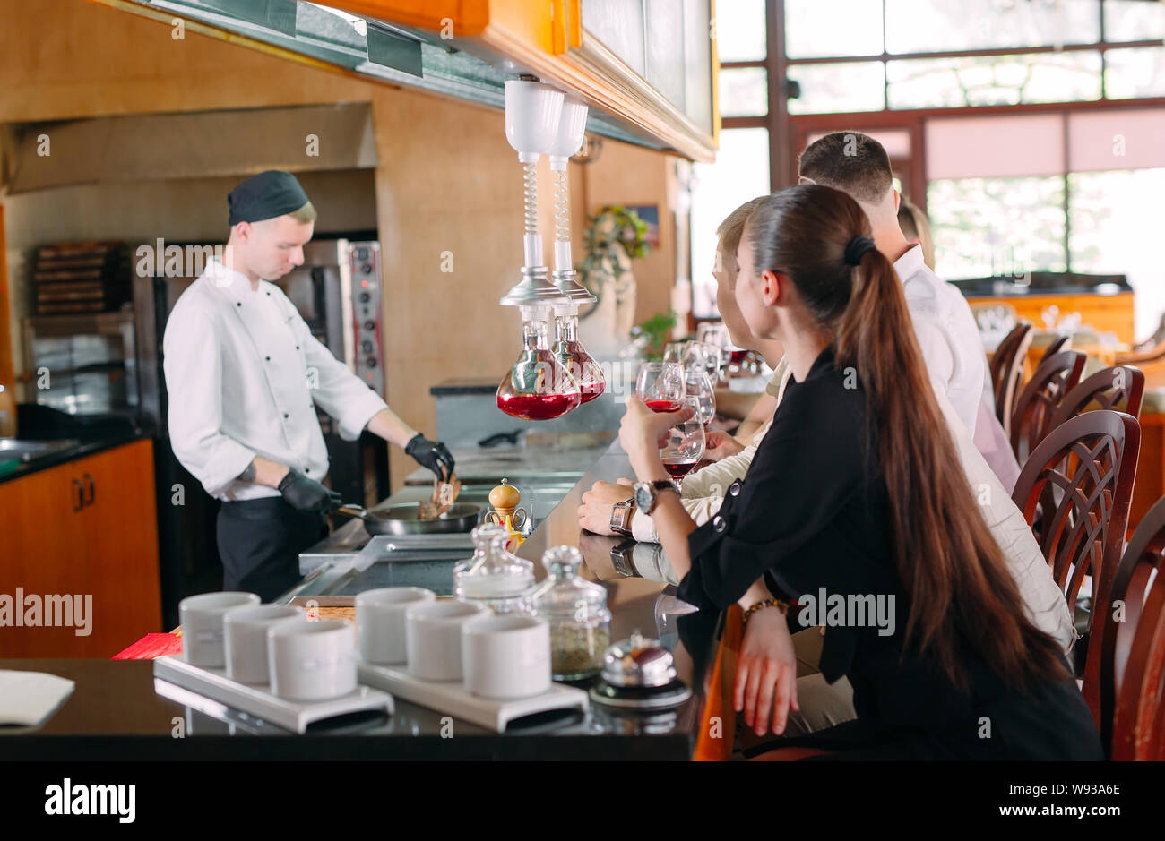The chef prepares food in front of the visitors in the restaurant Stock ...