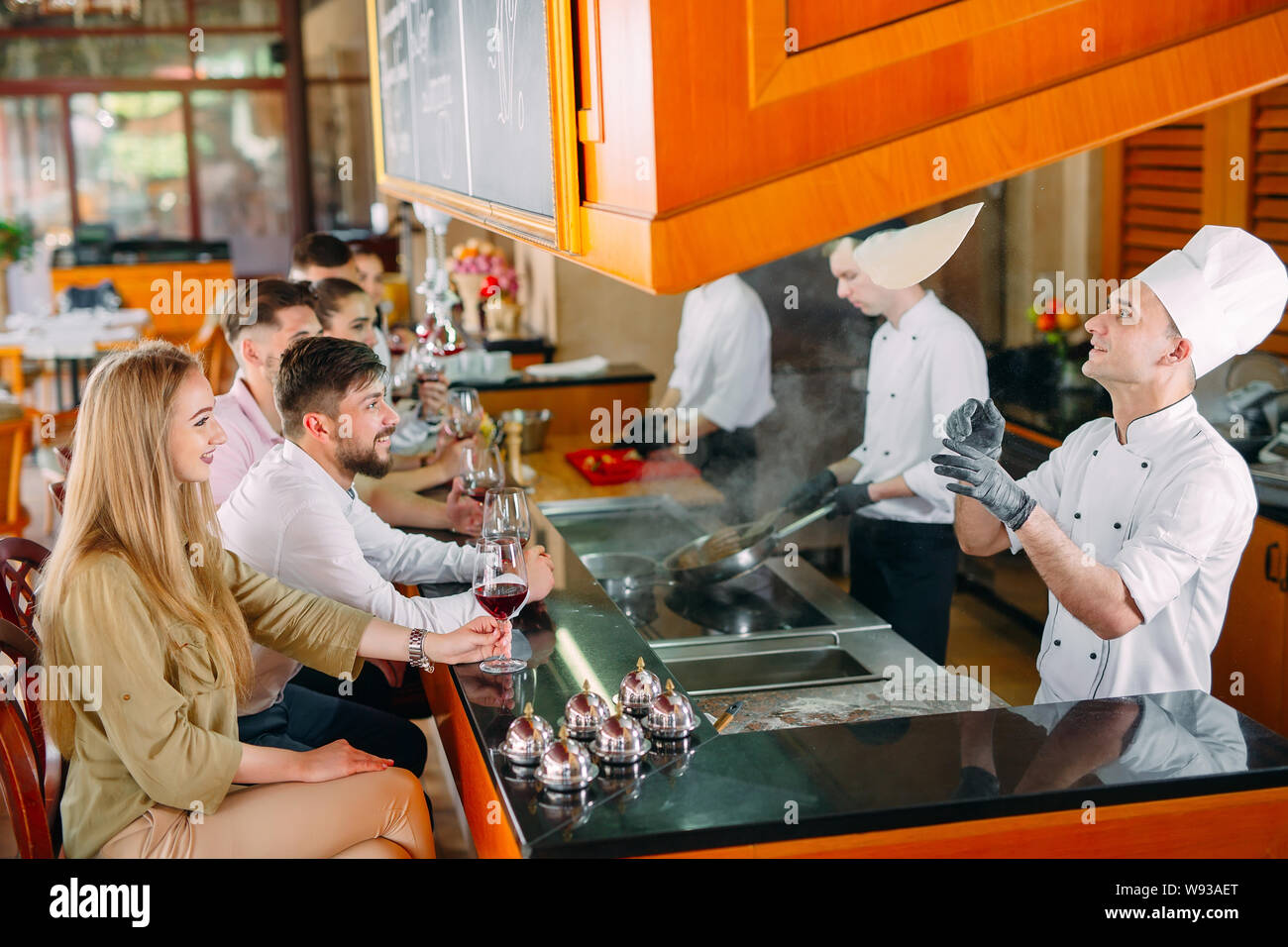 The chef prepares food in front of the visitors in the restaurant Stock ...