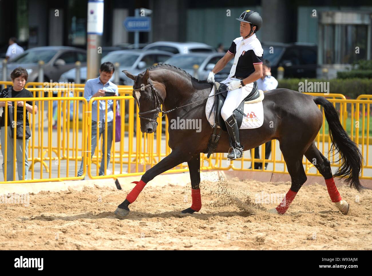 A Chinese horse trainer rides a horse during the Shanghai International ...