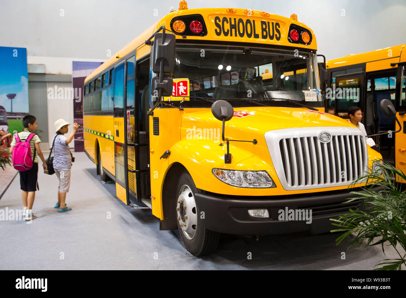 --FILE--Visitors look at a school bus displayed during an automobile ...