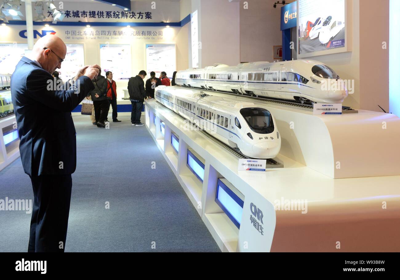--FILE--A foreign visitor takes photos of models of CRH (China Railway ...