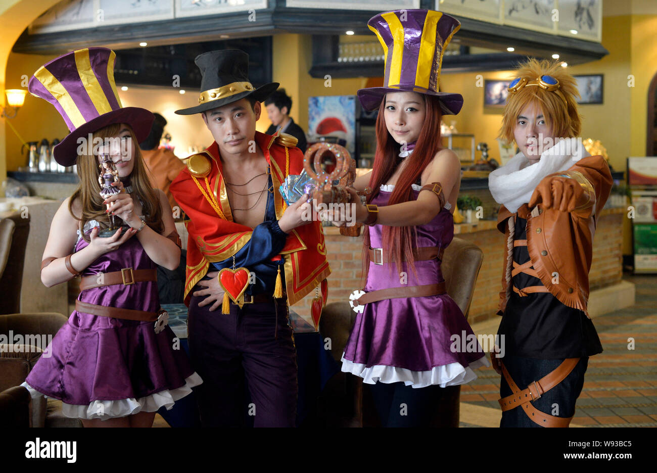 Two waiters and two waitresses in costumes of game League of Legends ...