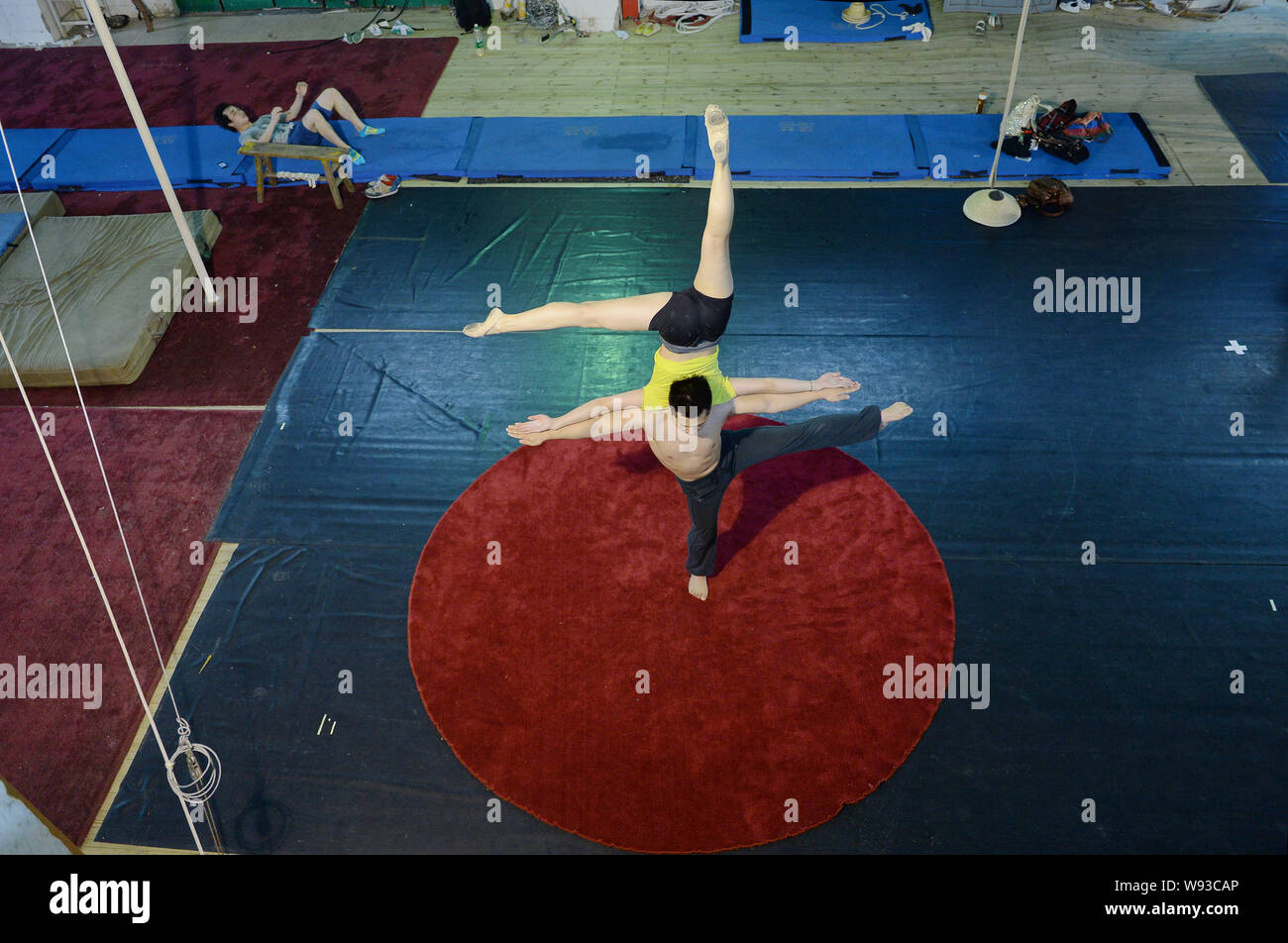 Young Chinese acrobats practice at the training center of the Soldier ...